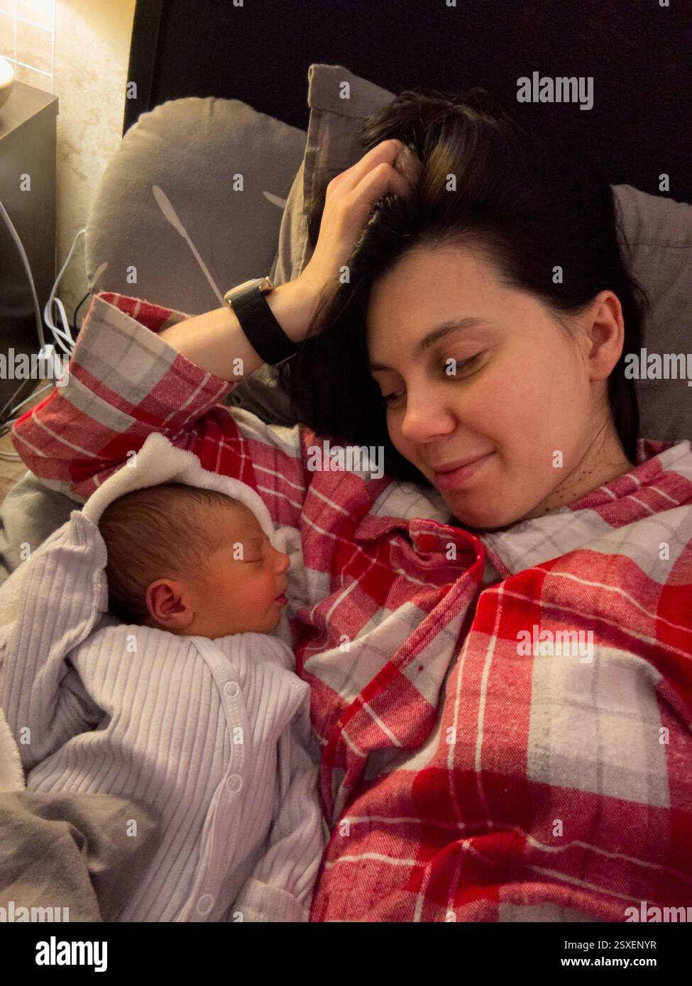 Smiling Mother and Newborn Bonding in Bed Stock Photo - Alamy