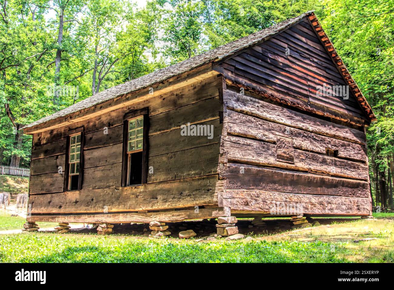 Small, old-fashioned house with a slanted roof. The house has a porch ...