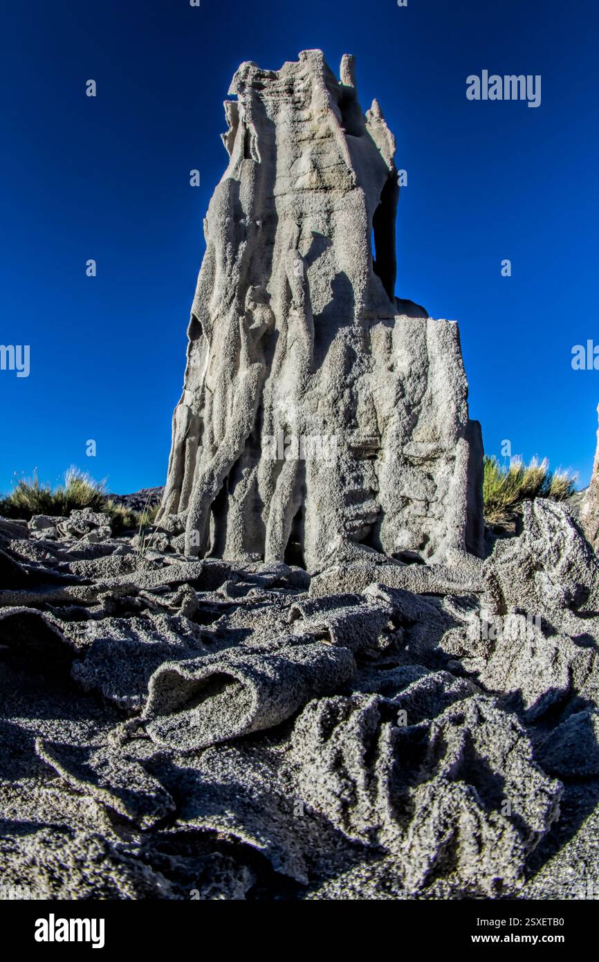 Large rock with a pile of white fabric on top of it. The fabric is ...
