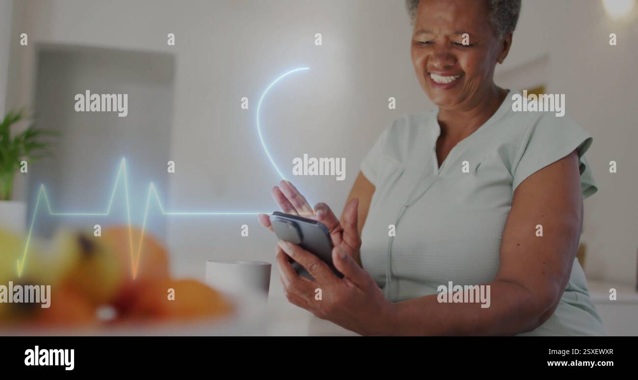 Image of heart shape cardiograph over senior biracial woman using ...