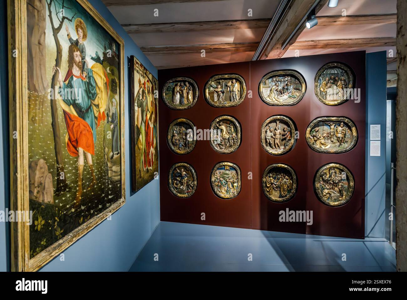 Religious art from Germany is displayed in a museum setting. Paintings ...
