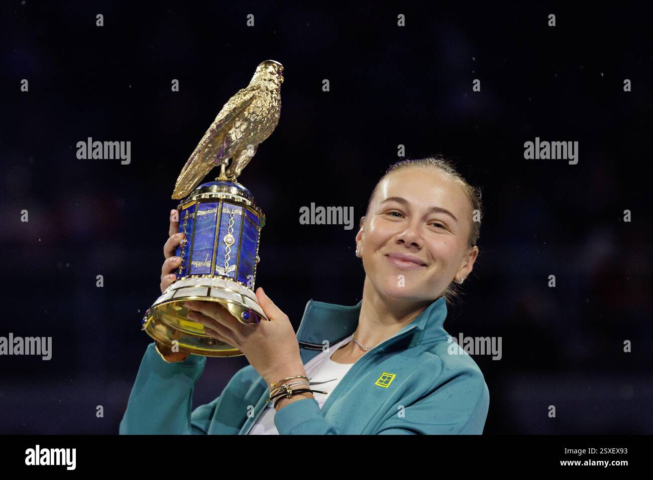 Amanda Anisimova of the United States holds the trophy during the Qatar ...