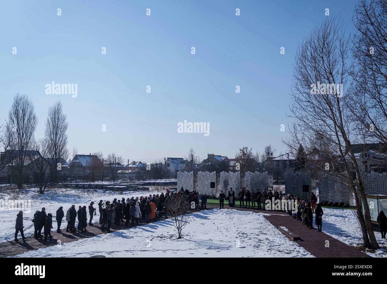 People attend a memorial ceremony for killed civilians to mark the ...