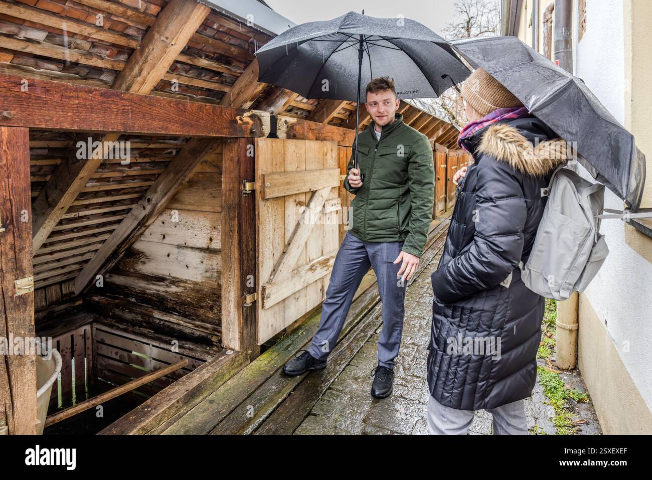 Anton Karnbaum with travel journalist Angela Berg watching carp in a ...