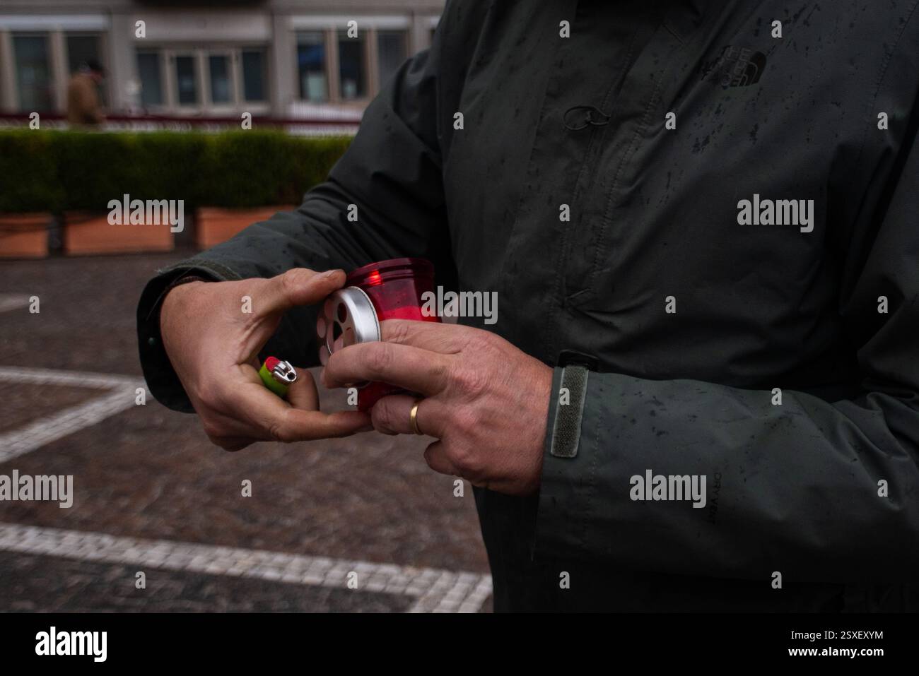 Rome, Italy. 24th Feb, 2025. A man lights a candle outside Rome's ...