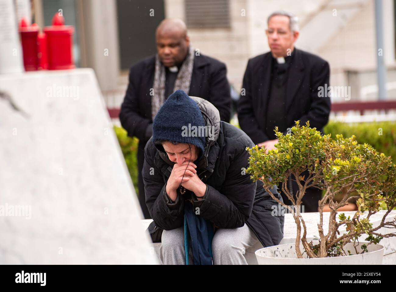 Rome, Italy. 24th Feb, 2025. Faithful pray in front of the statue of ...