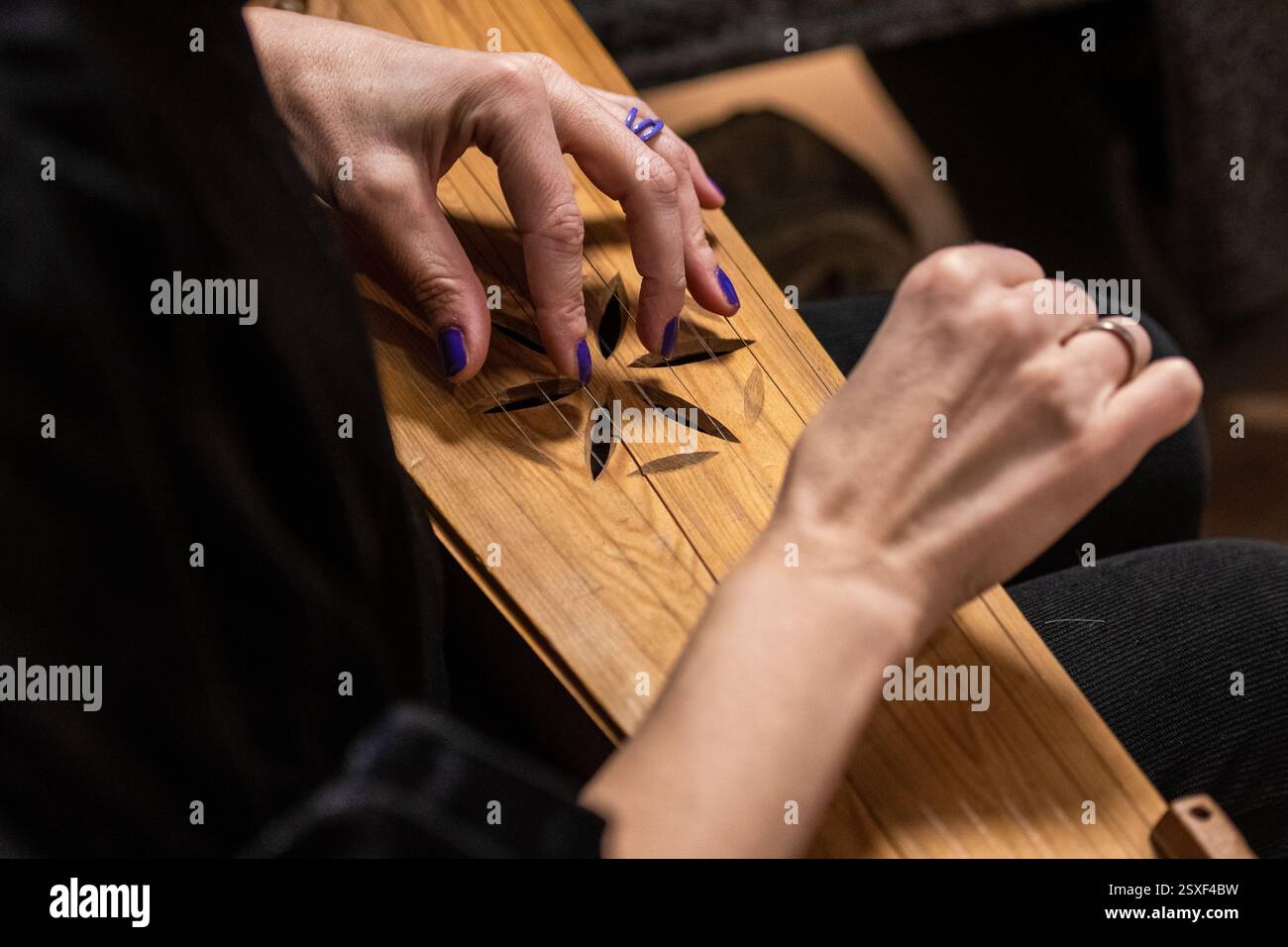 Fingers of a girl playing kankles, Lithuanian plucked string instrument ...