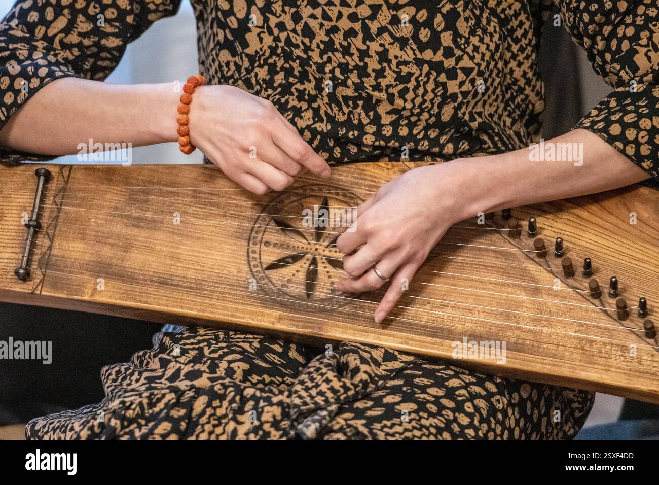 Fingers of a girl playing kankles, Lithuanian plucked string instrument ...