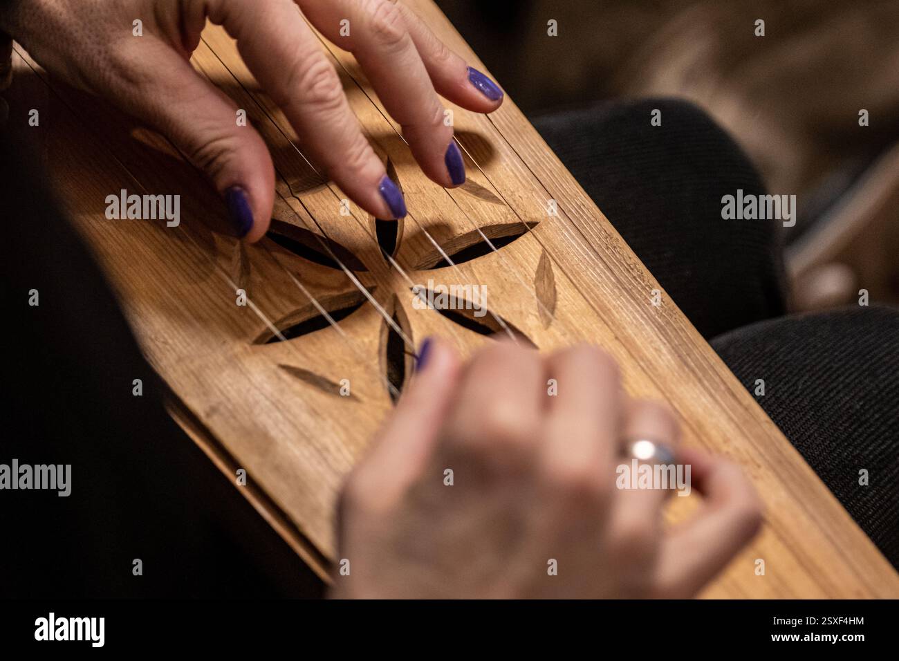 Fingers of a girl playing kankles, Lithuanian plucked string instrument ...