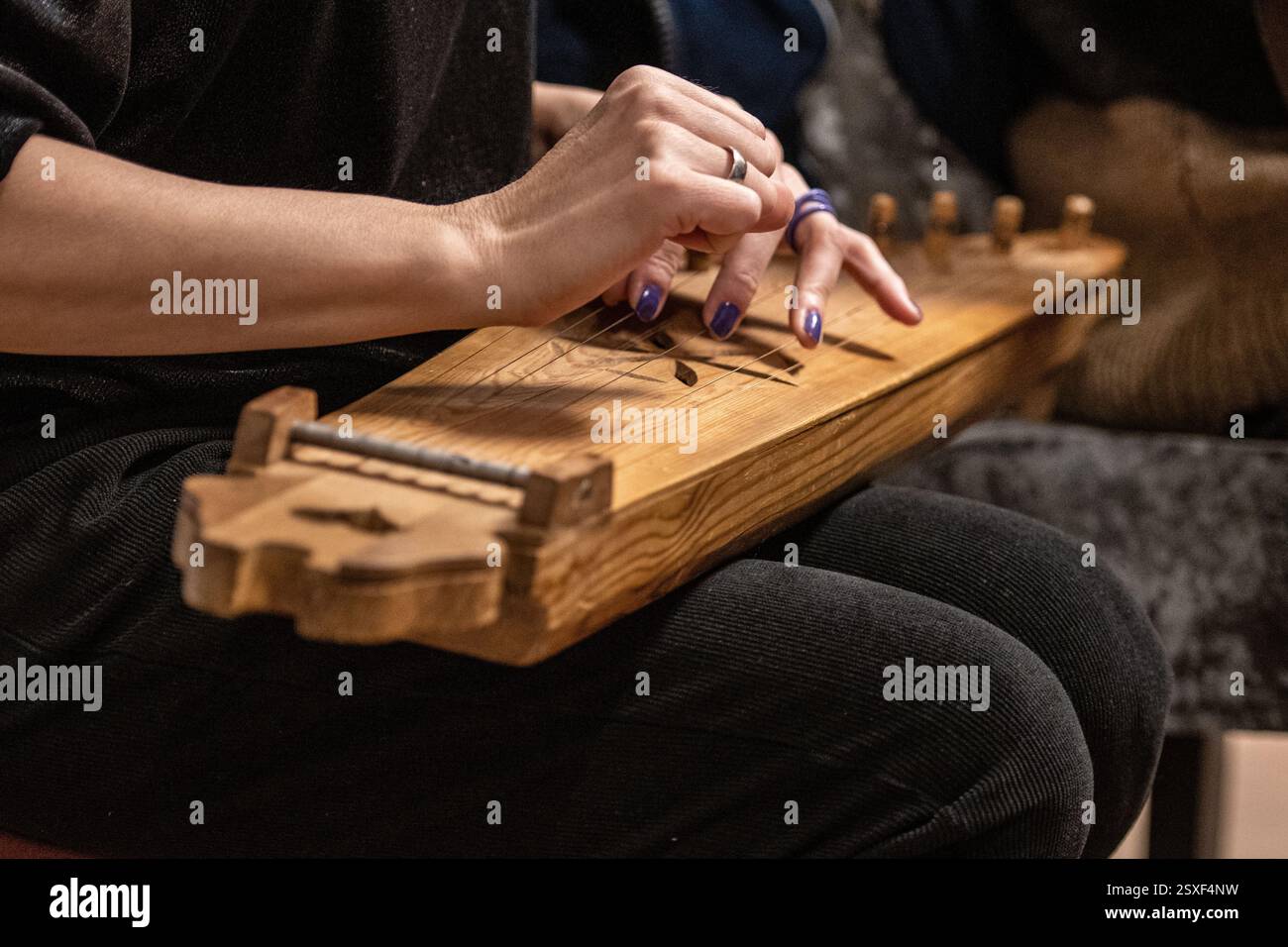 Fingers of a girl playing kankles, Lithuanian plucked string instrument ...