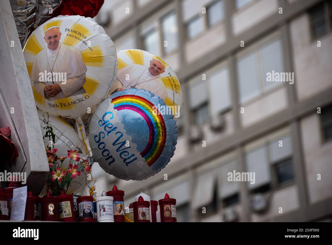 Balloons have been left by faithful under the statue of Pope John Paul ...