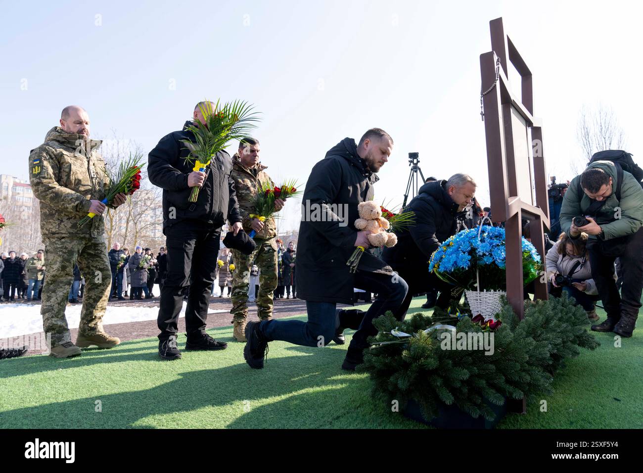 Bucha, Kyiv Region, Ukraine. 24th Feb, 2025. Officials laying down ...