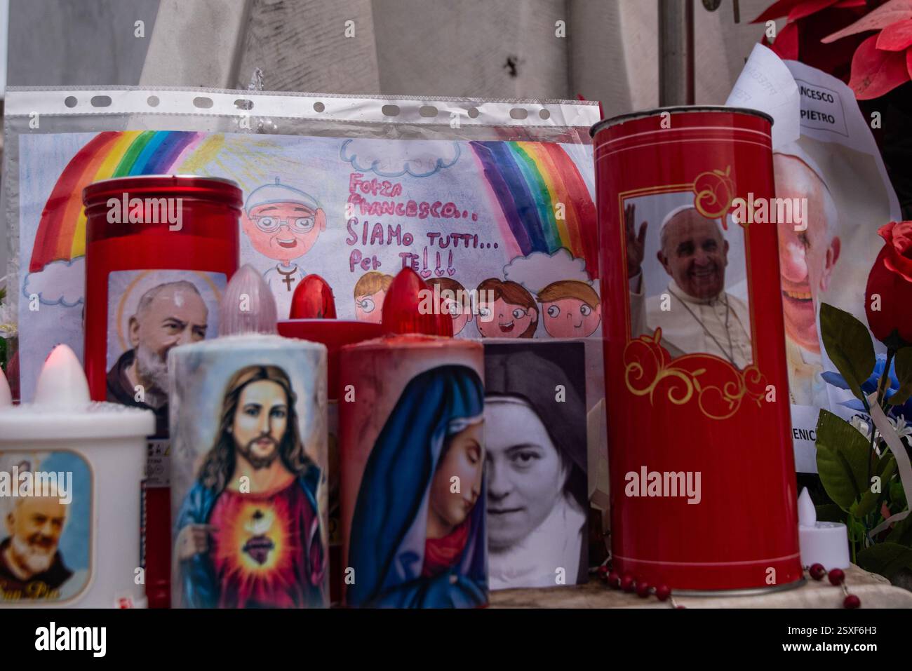 Rome, Italy. 24th Feb, 2025. Tributes of flowers, images, candles, and ...