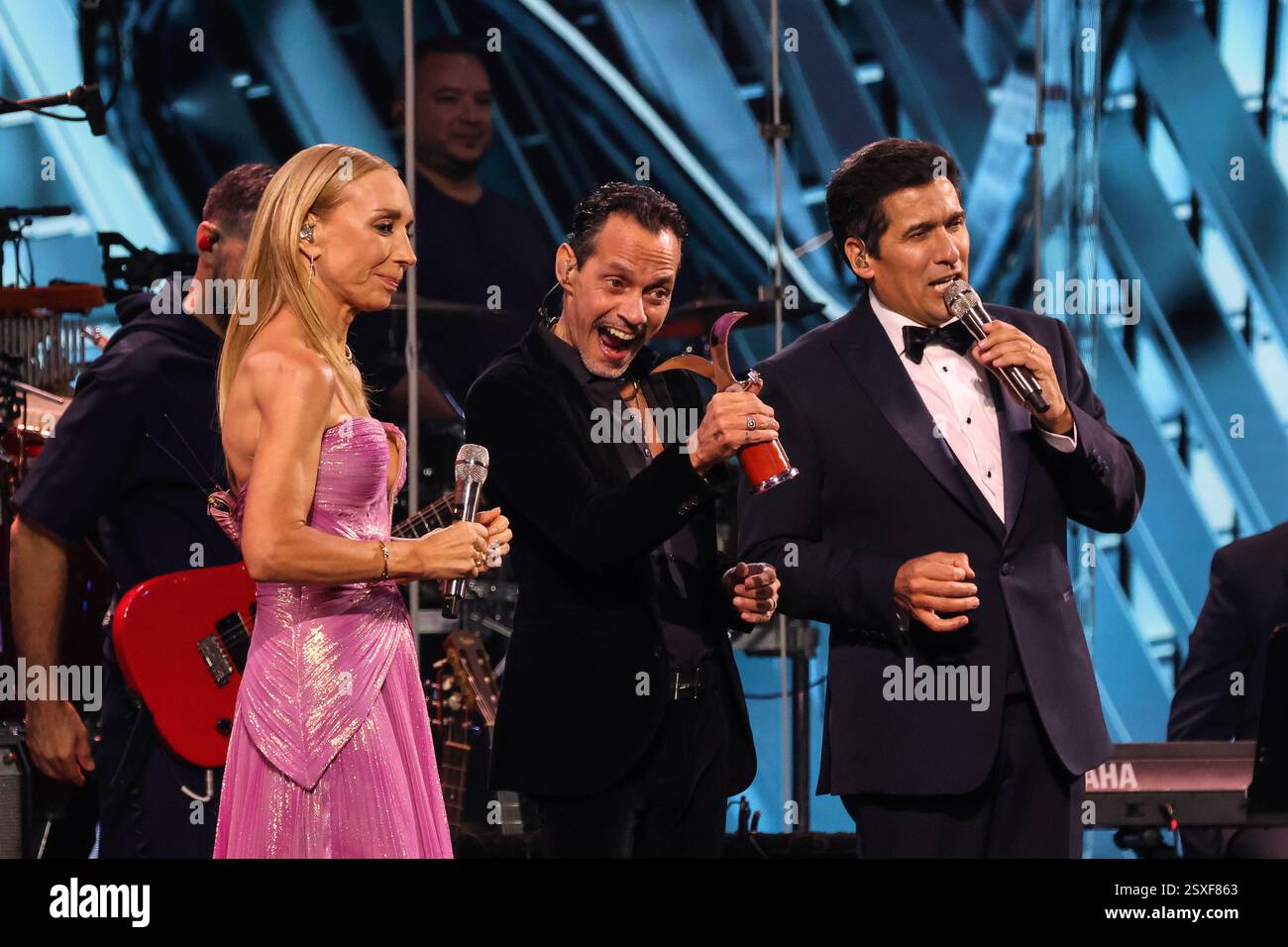 Singer Marc Anthony shows off his award in concert during the 64th Viña ...