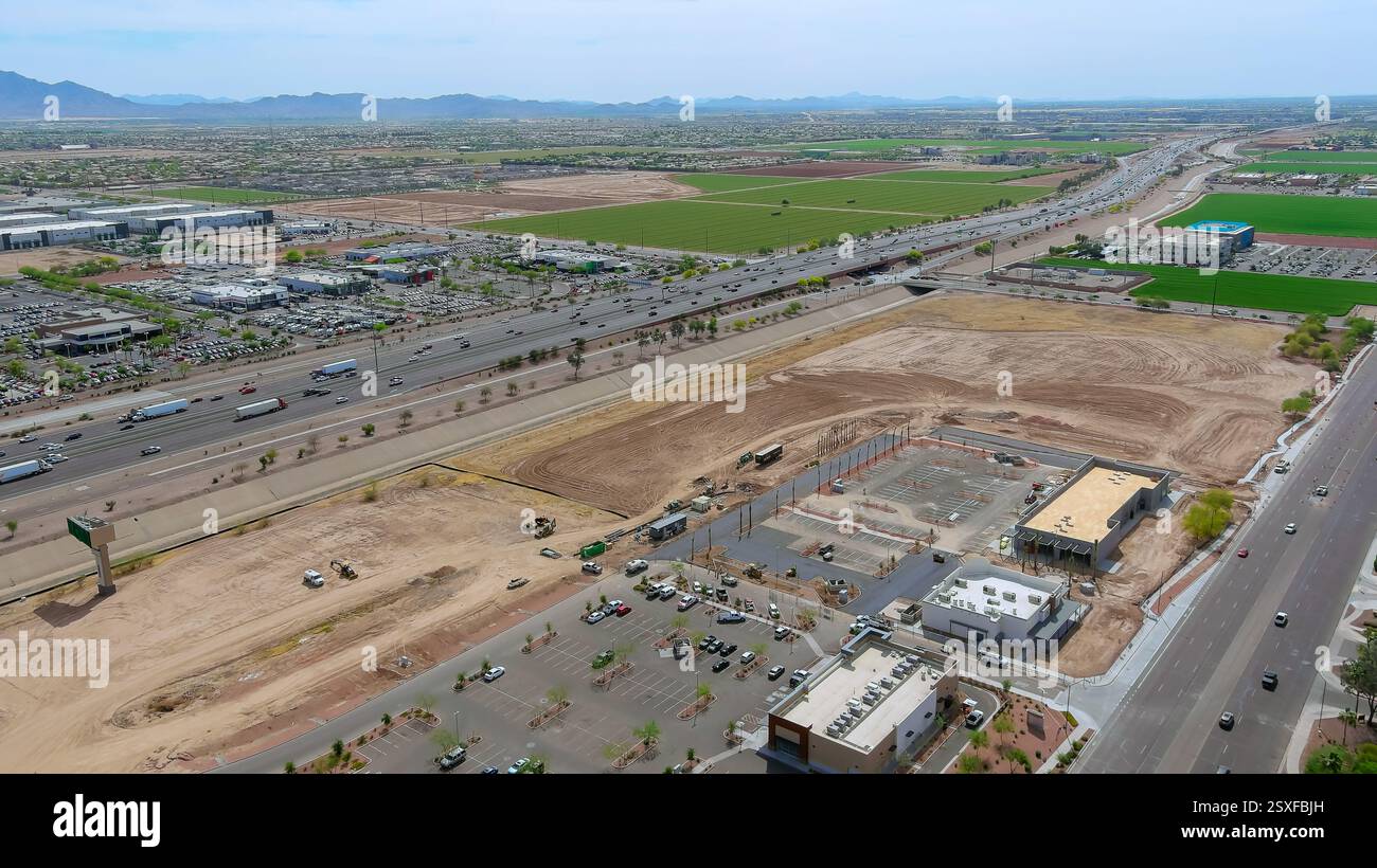 Aerial view of heavy traffic on highway next to construction site ...