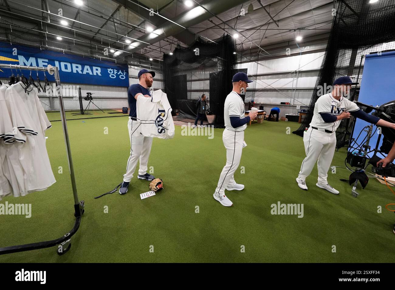 Tampa Bay Rays pitcher Zack Littell, left, dons a uniform for the team ...