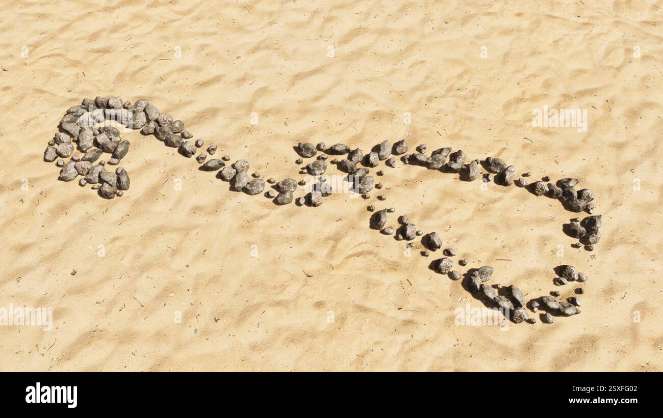 Concept conceptual stones on beach sand handmade symbol shape, golden ...