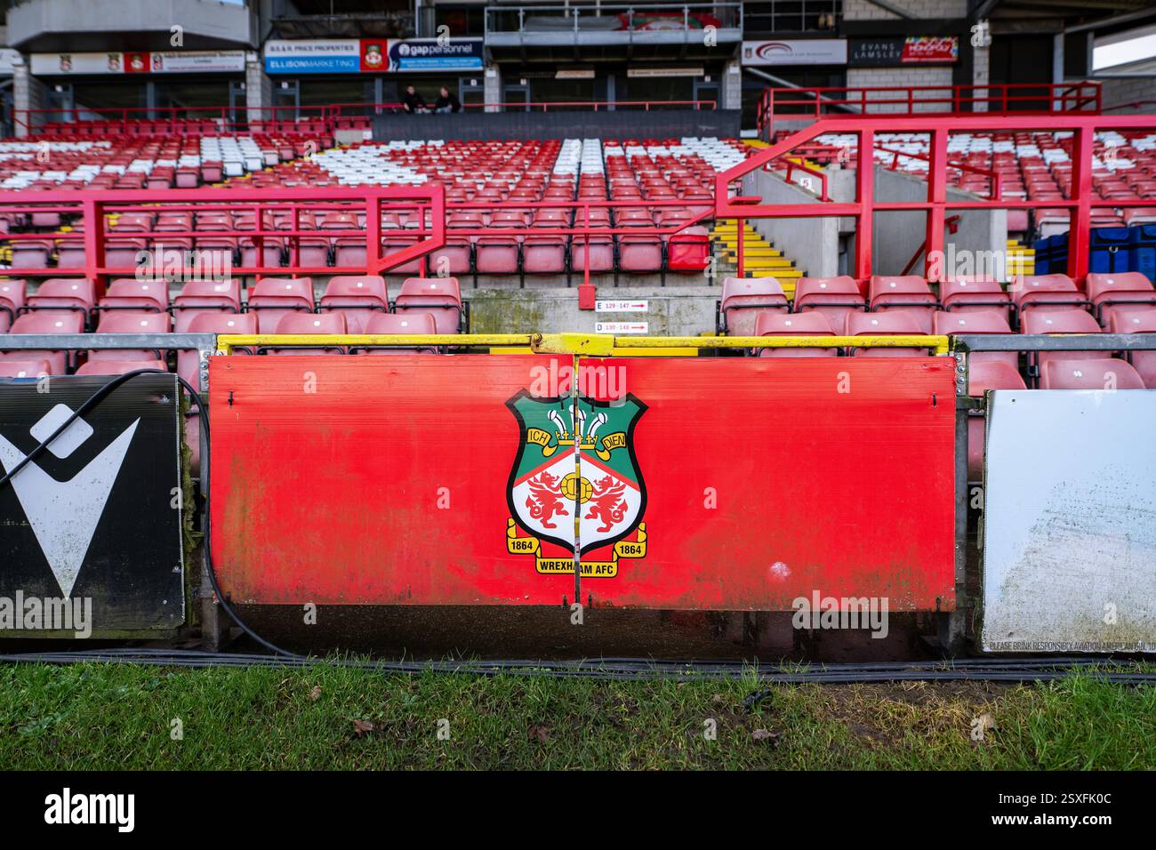 250224 The club Crest of Wrexham is seen below stands at Racecourse ...