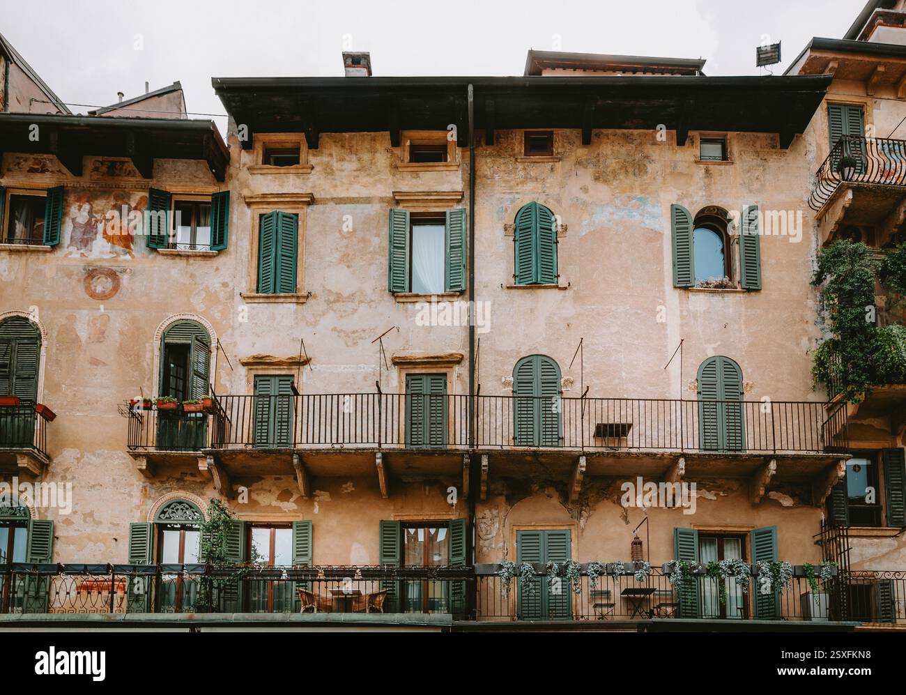 Residential building featuring charming balconies and vibrant green ...