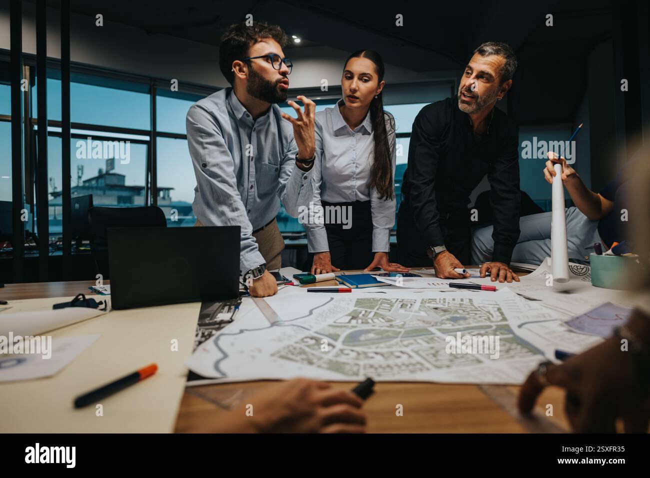 Team strategizing during a collaborative business meeting in modern ...