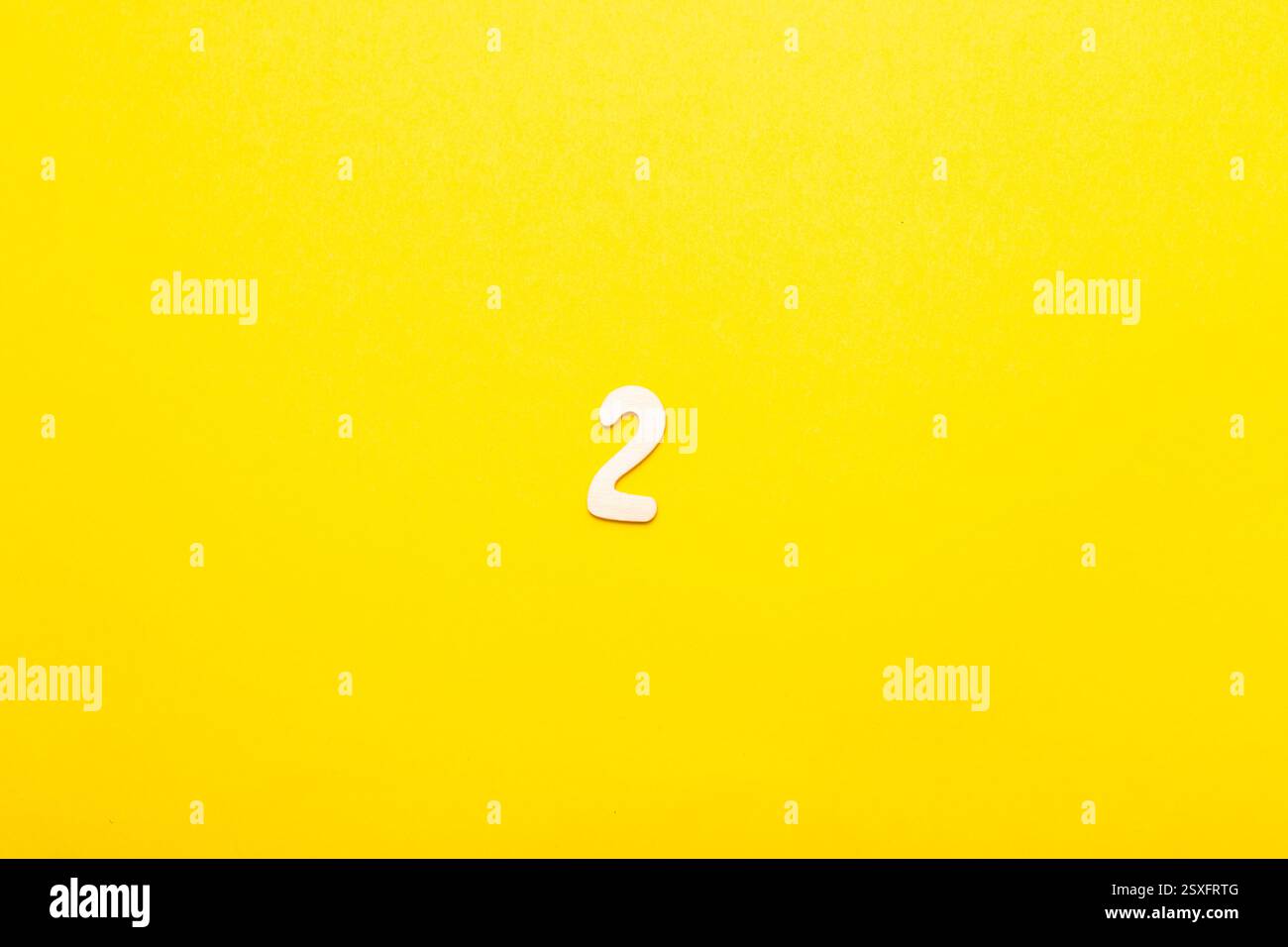 Top view of wooden number 2 two on yellow bright background. Calendar ...