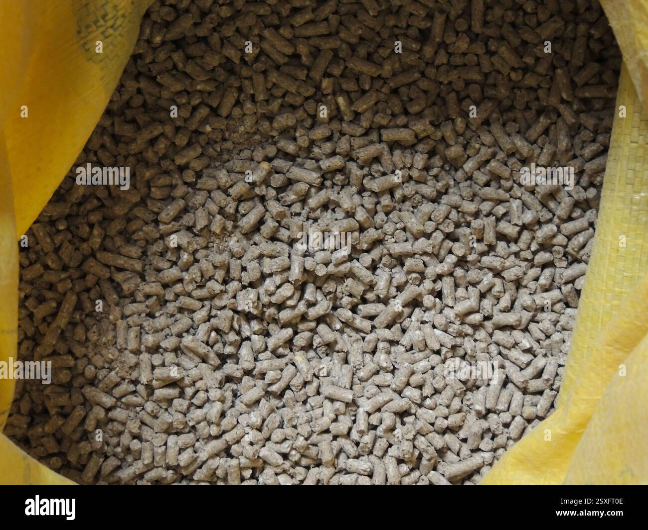 chicken feed pellets in yellow plastic bag close-up, feeding poultry ...