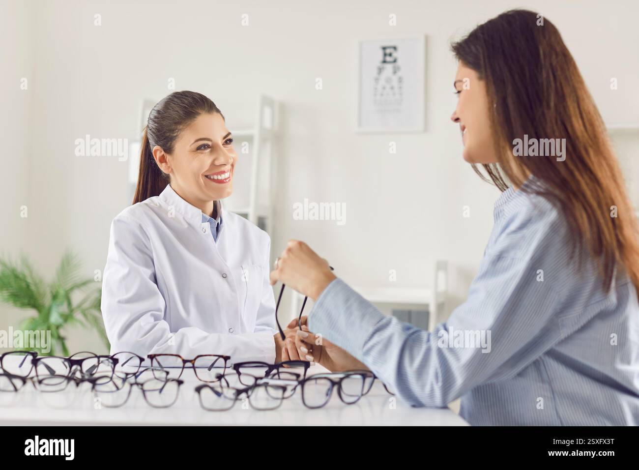Ophthalmologist Helping Patient Choose Eyeglasses During Clinic Visit ...