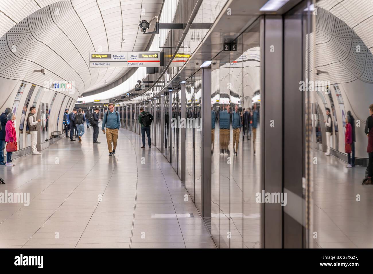 Passengers waiting on a busy platform of Tottenham Court Road station ...