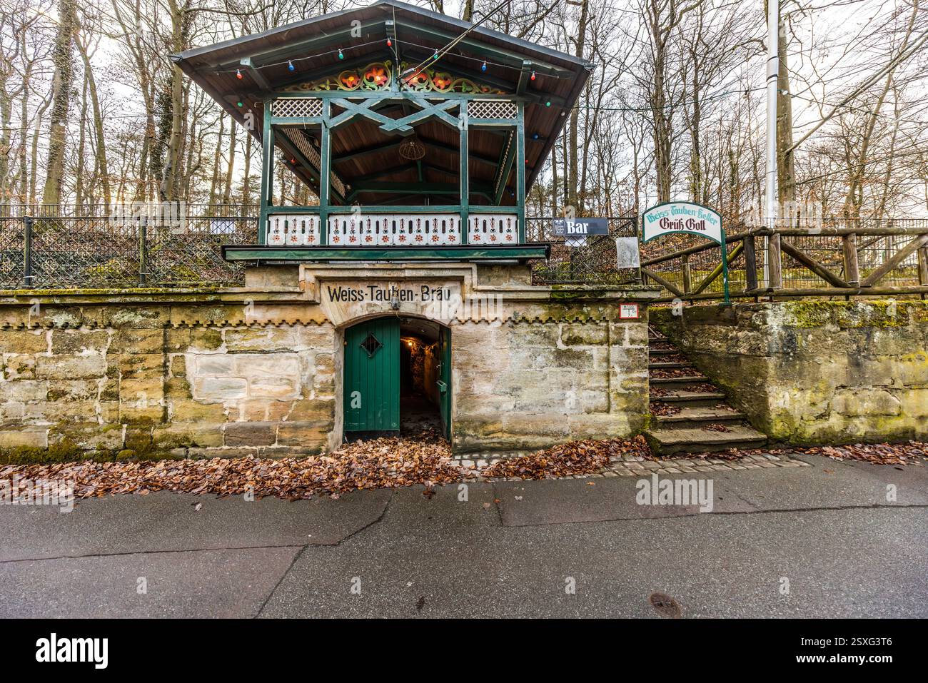 A covered outdoor beer garden in Germany called Weiß-Taufen-Bräu is ...