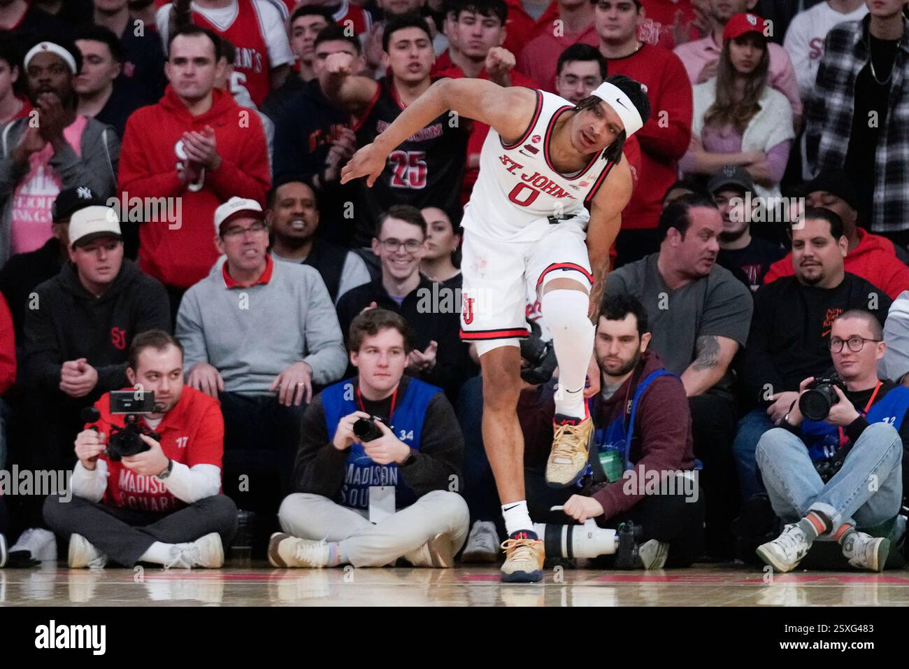 St. John's Aaron Scott puts his shoe back on during the second half of ...