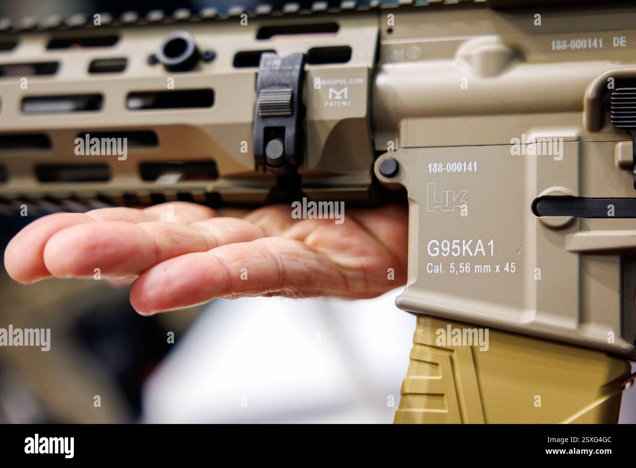 Nuremberg, Germany. 24th Feb, 2025. A man holds the G95 KA1 assault ...