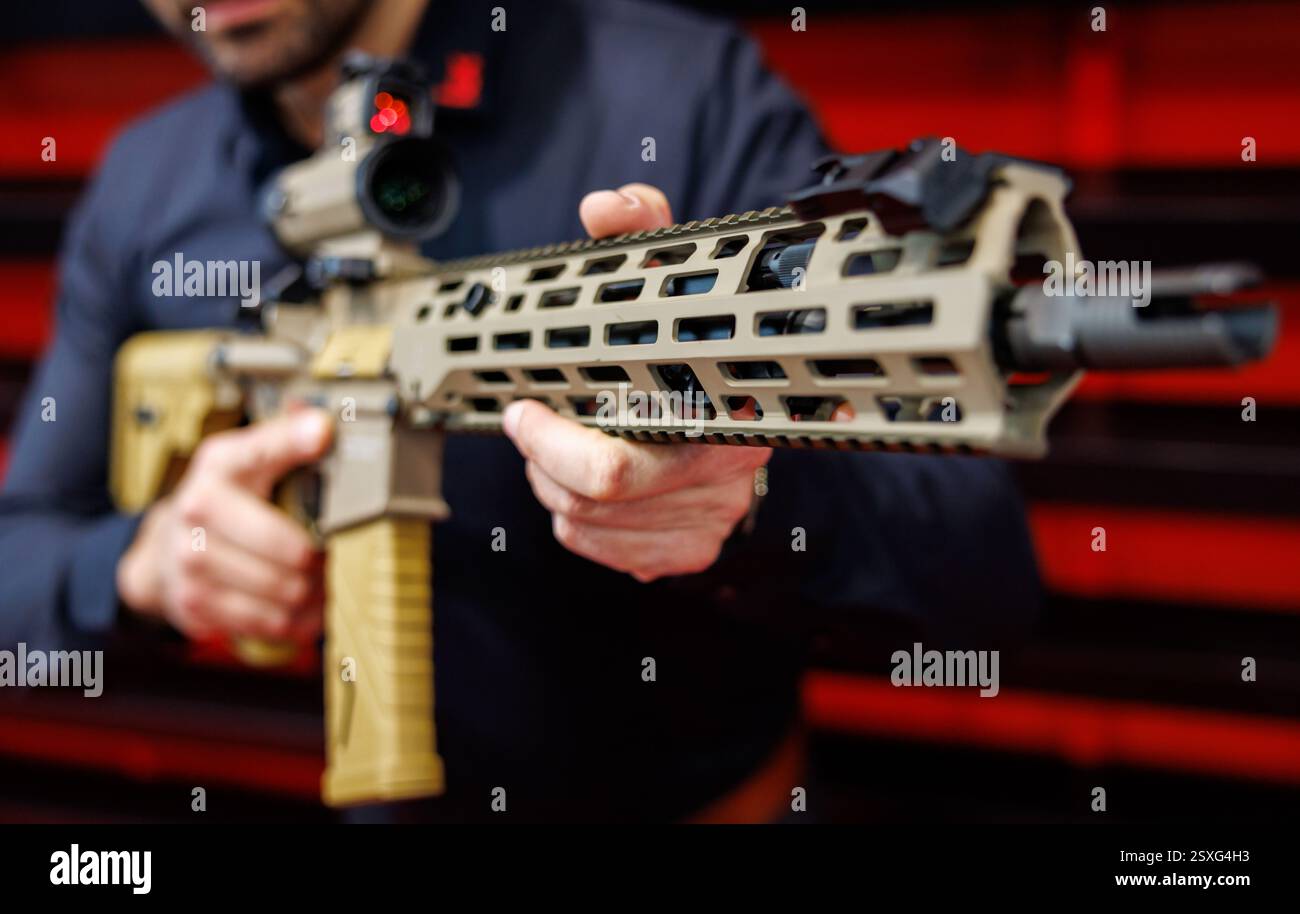Nuremberg, Germany. 24th Feb, 2025. A man holds the G95 KA1 assault ...