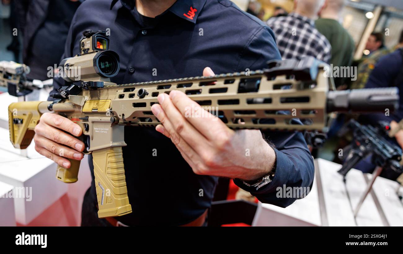 Nuremberg, Germany. 24th Feb, 2025. A man holds the G95 KA1 assault ...