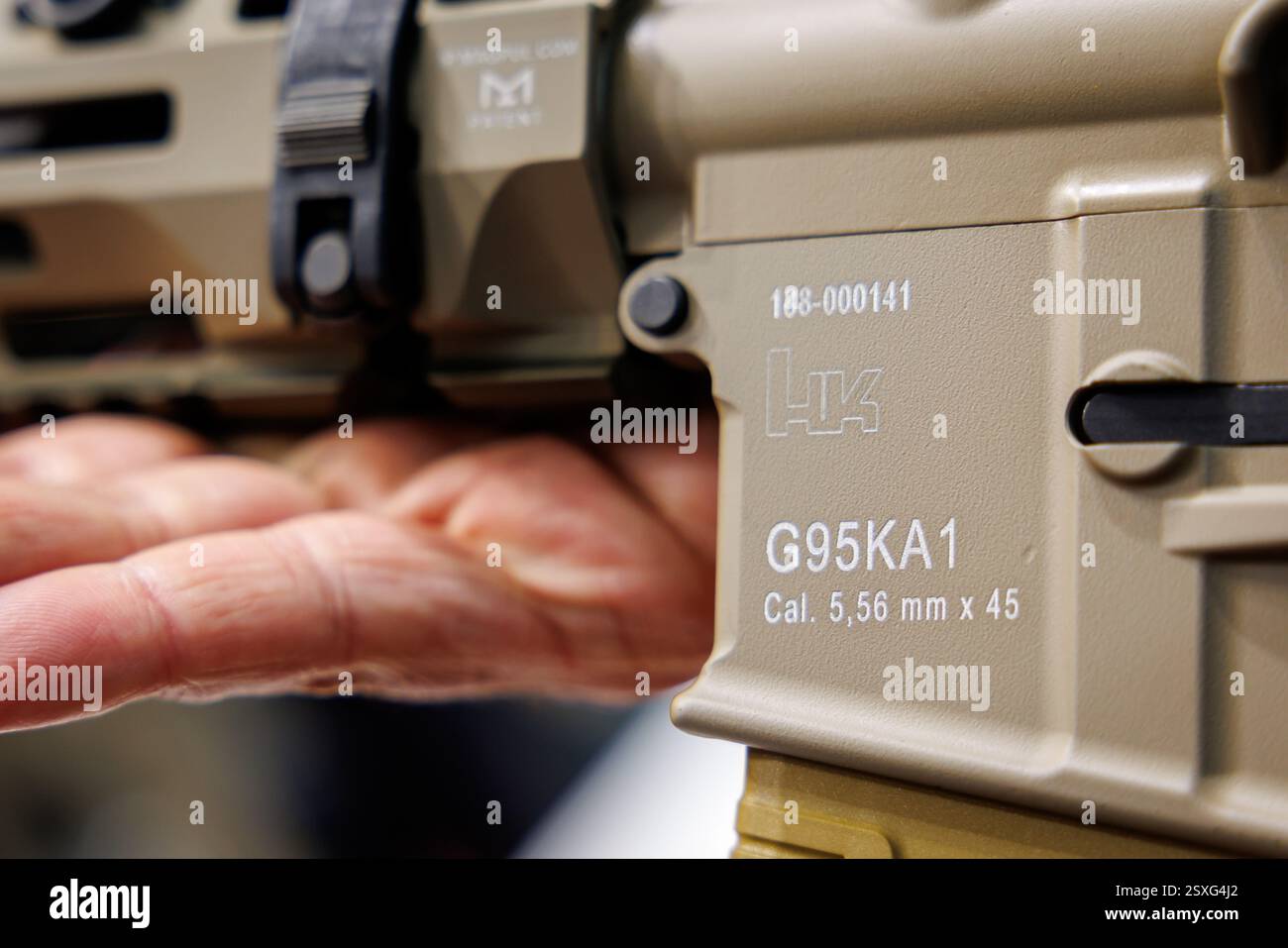 Nuremberg, Germany. 24th Feb, 2025. A man holds the G95 KA1 assault ...