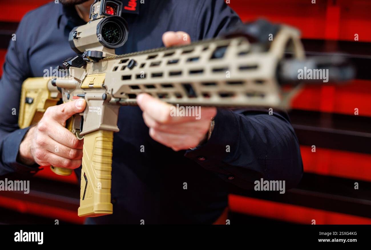 Nuremberg, Germany. 24th Feb, 2025. A man holds the G95 KA1 assault ...