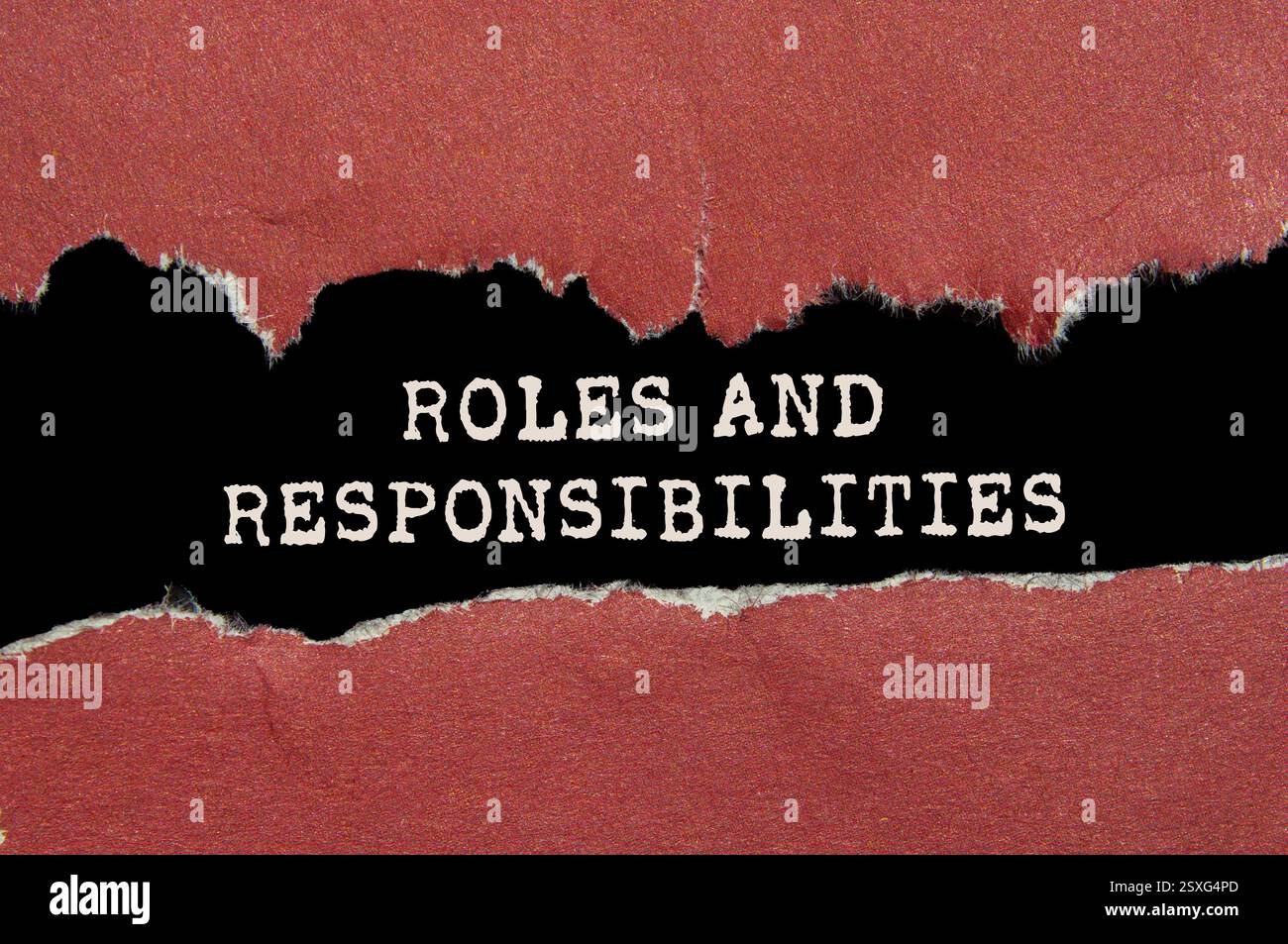 Roles and responsibilities message written on ripped torn red paper on black background ...
