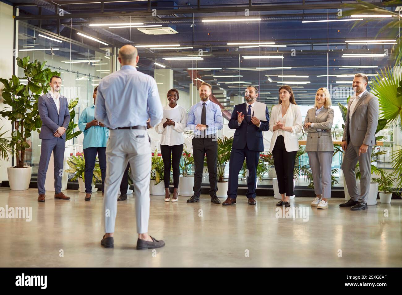Back view of business leader or coach speaking to group of diverse ...