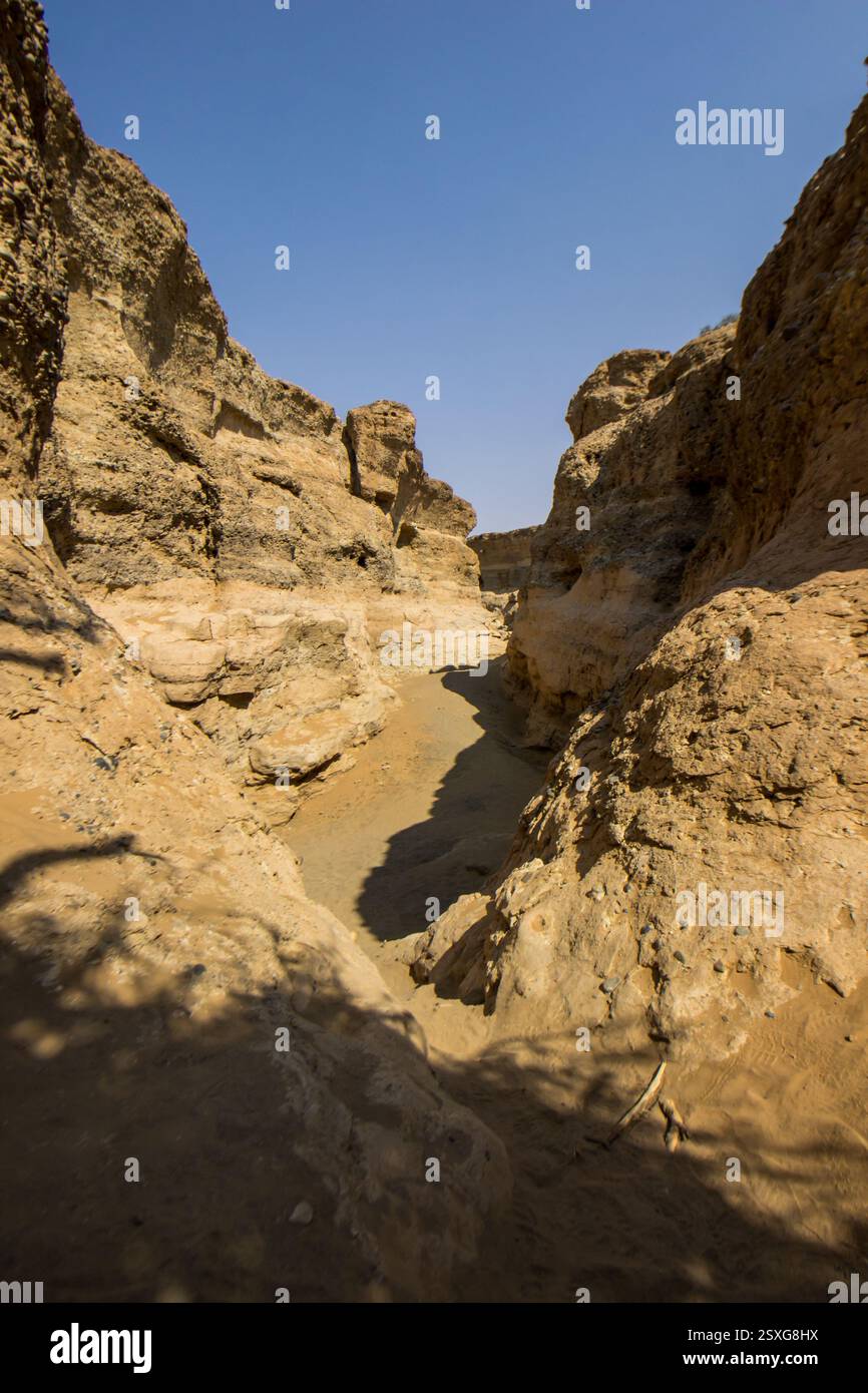 The dry bed among the high steep conglomerate cliffs of the narrow ...