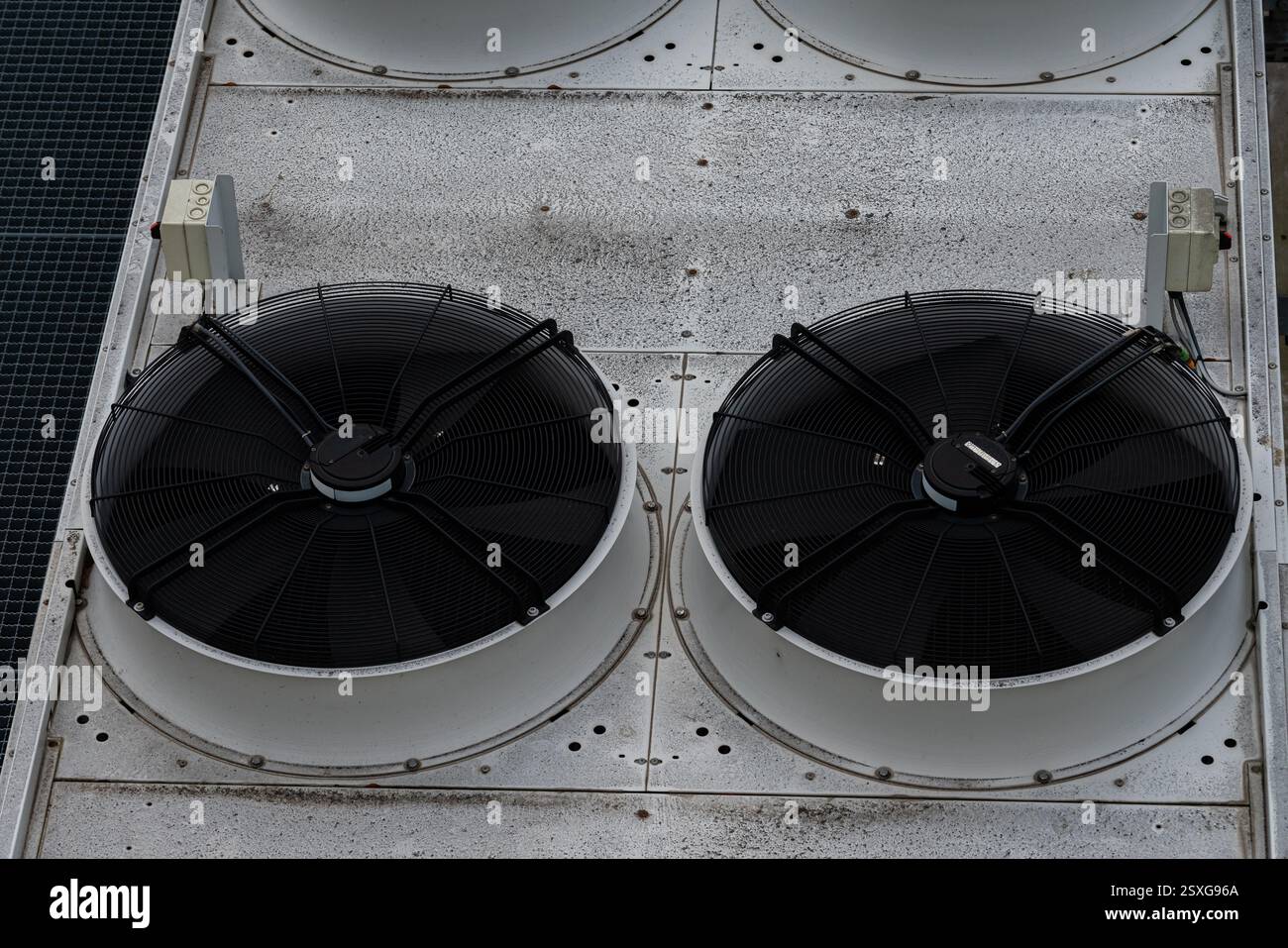Large cooling units are situated on the rooftop of a commercial ...