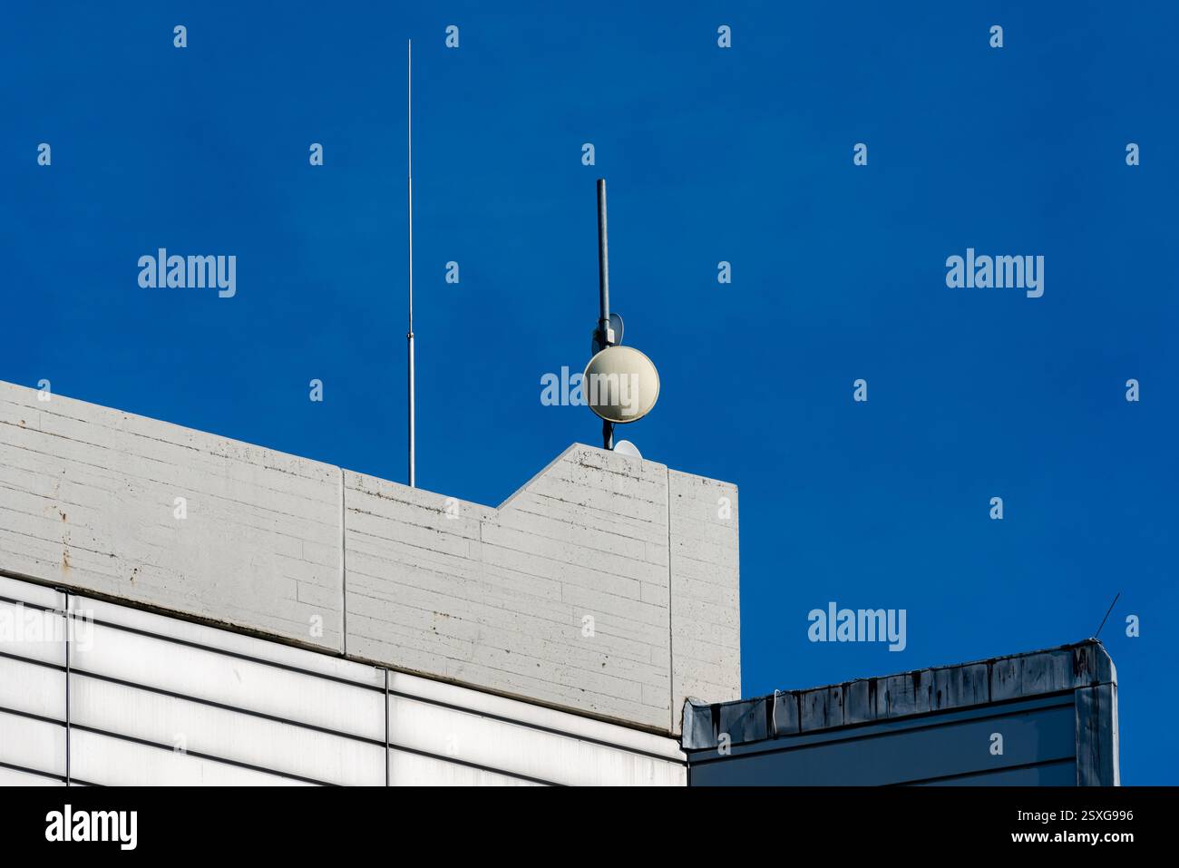 A building features a striking architectural detail at its roof ...