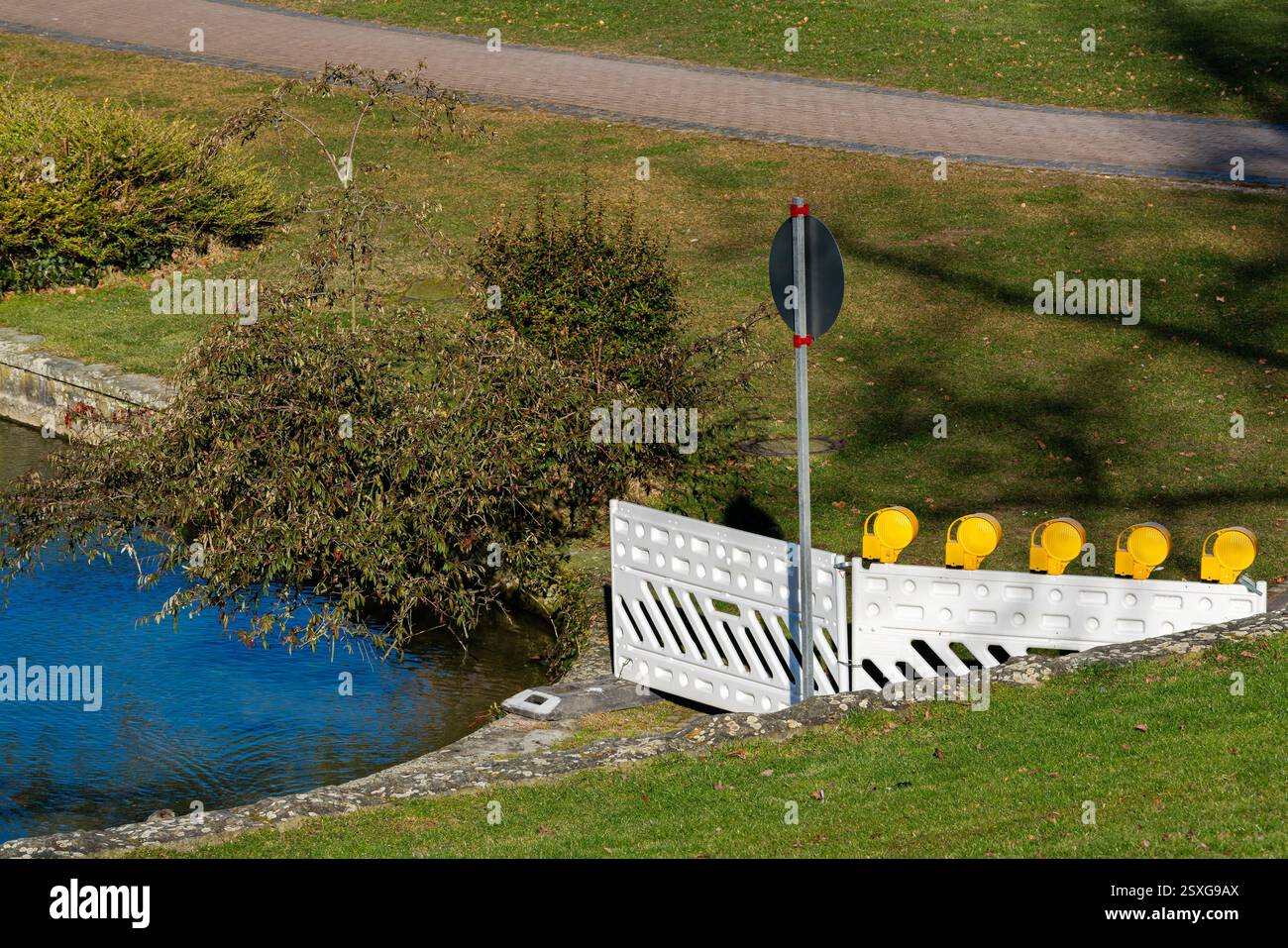A water control structure is visible by a calm pond, featuring a ...