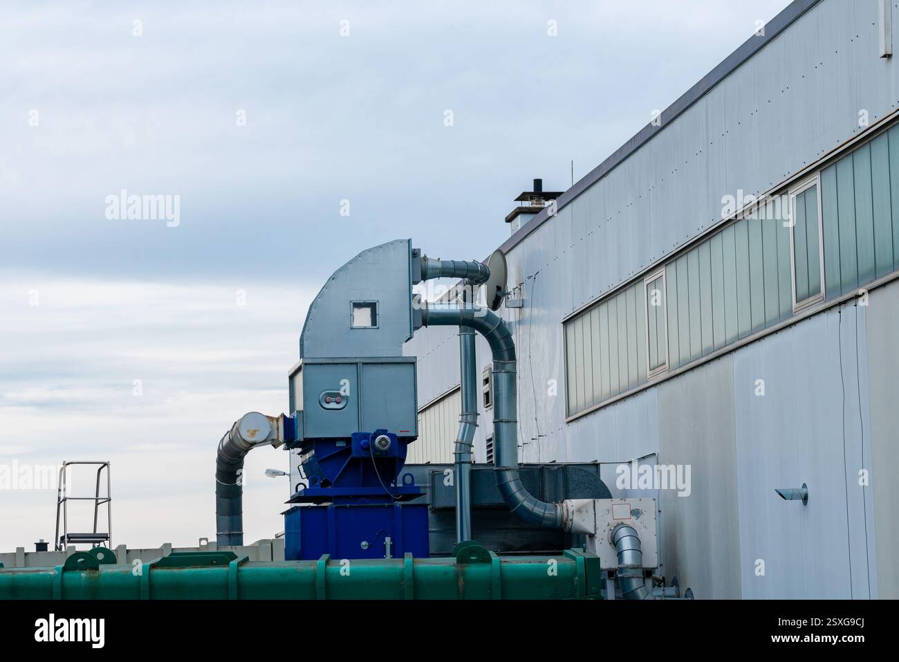 The image shows an industrial ventilation system attached to a building ...