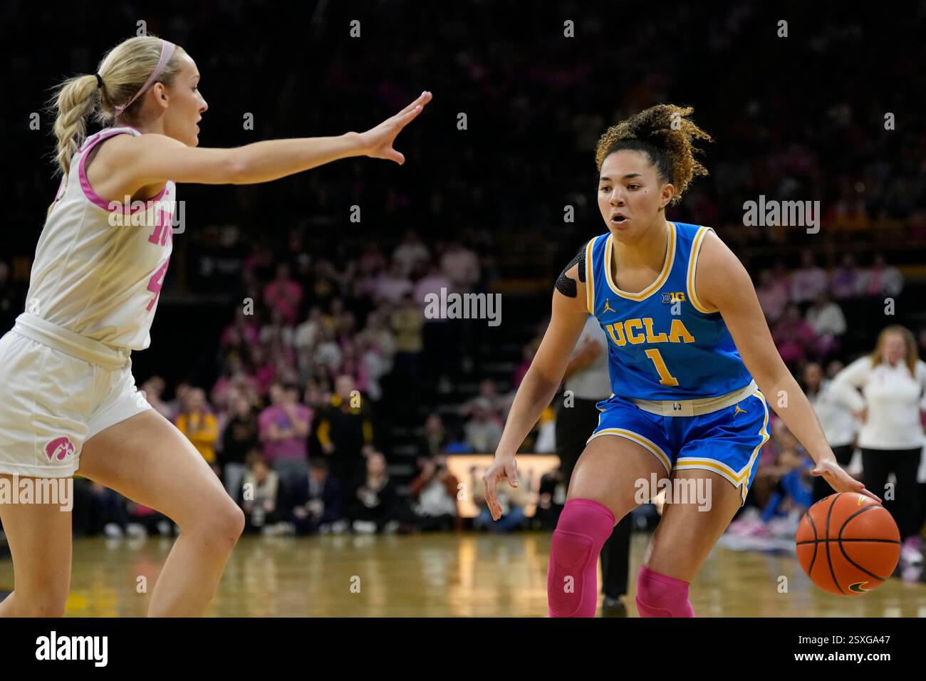 UCLA guard Kiki Rice (1) drives past Iowa guard Kylie Feuerbach (4 ...
