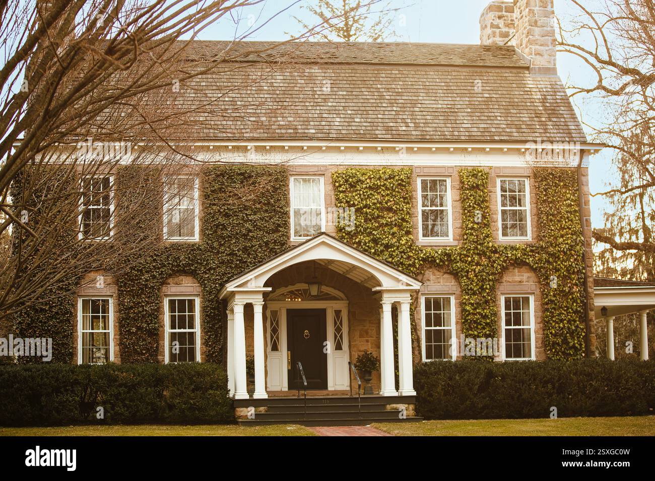 A house covered in creeper greenery on the facade, in Princeton, New ...