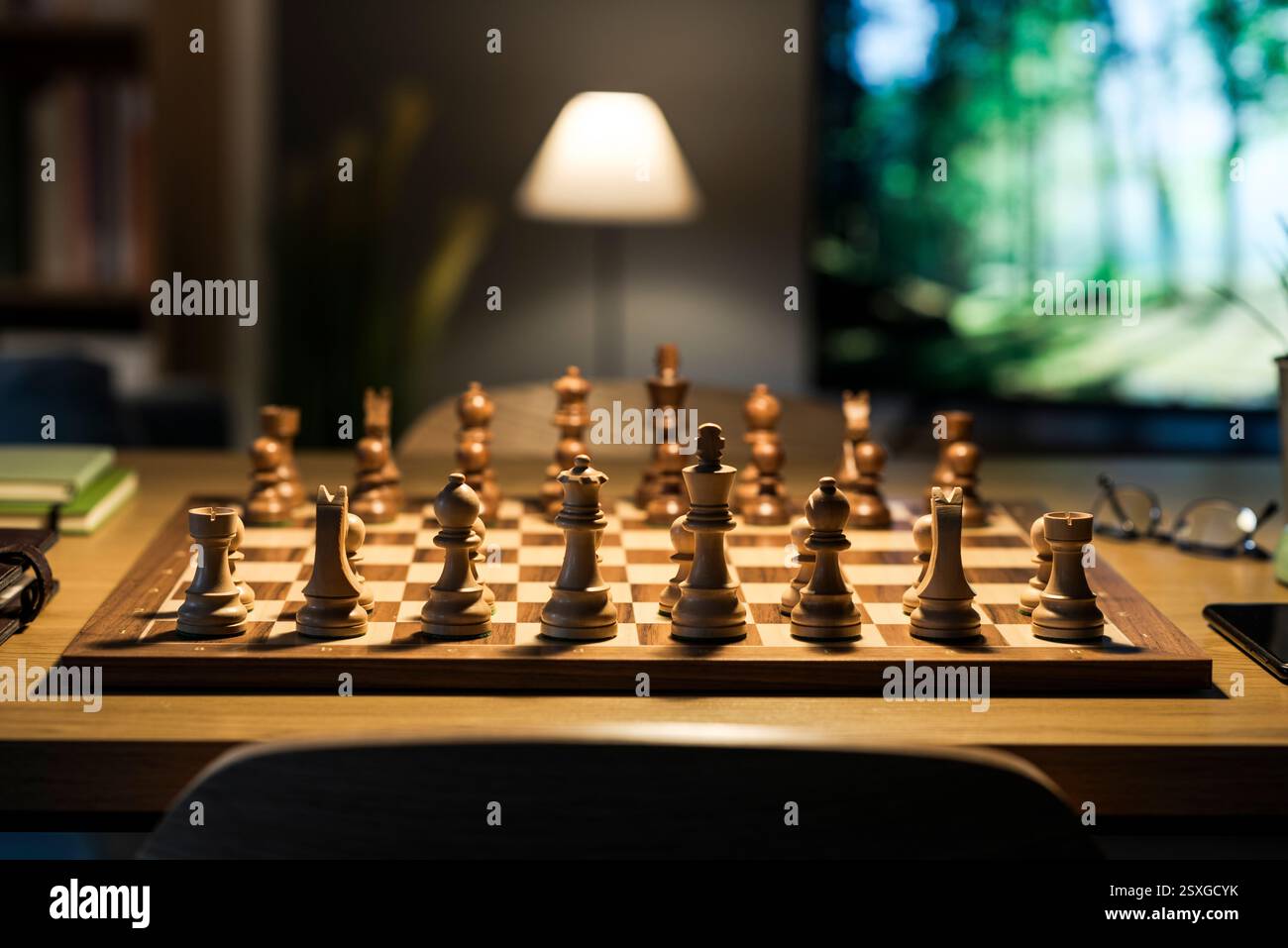 Wooden chessboard and chess pieces on a desk at home, competition and ...