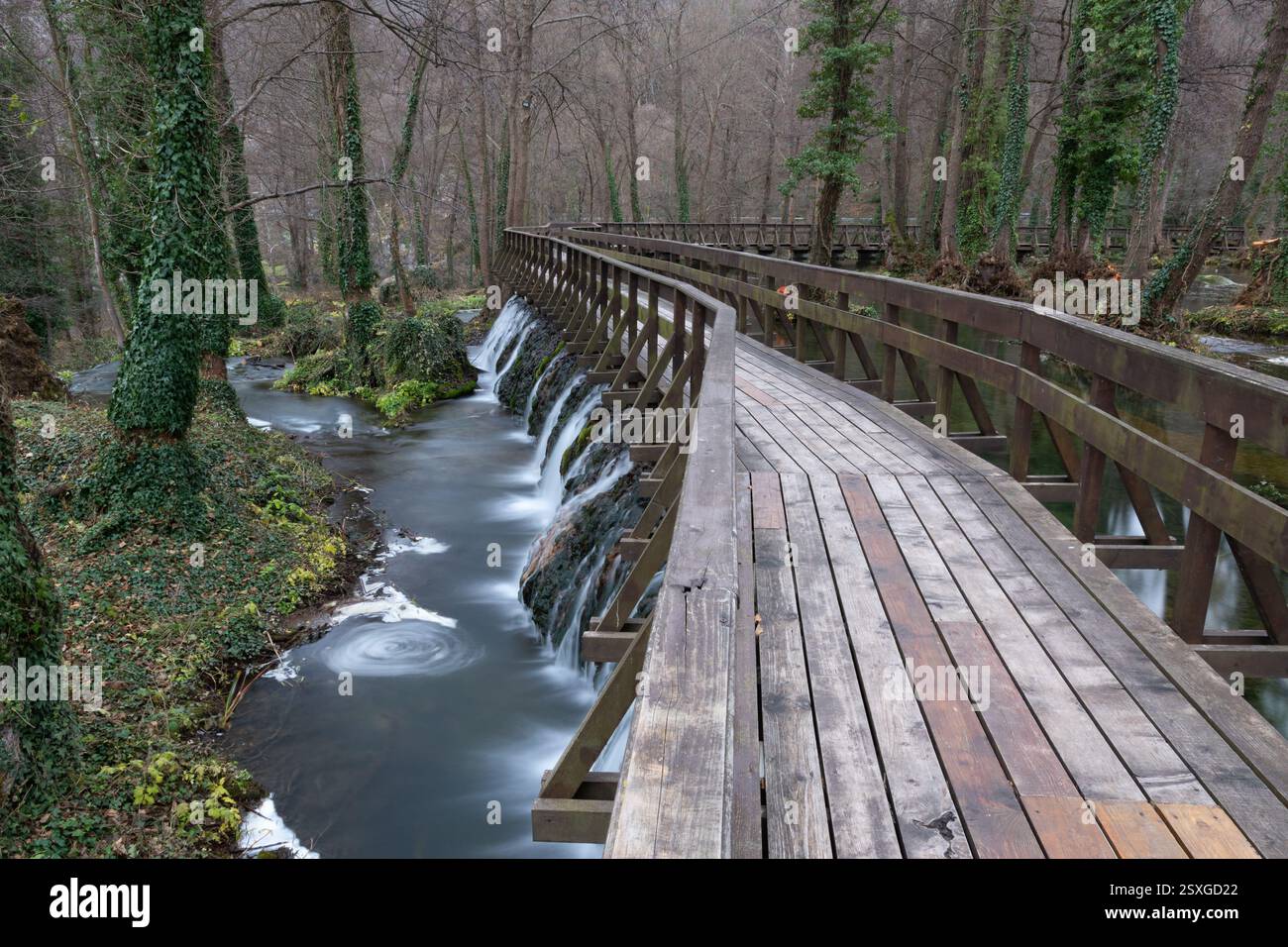 Winding wooden pedestrian bridge on Pliva lake near Jajce Stock Photo ...