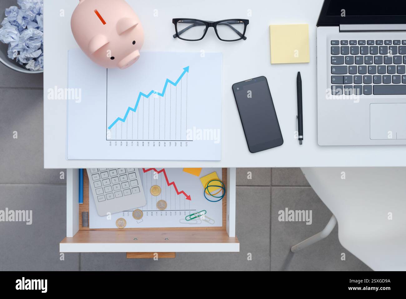 Corporate business desk with open drawer containing hidden financial ...