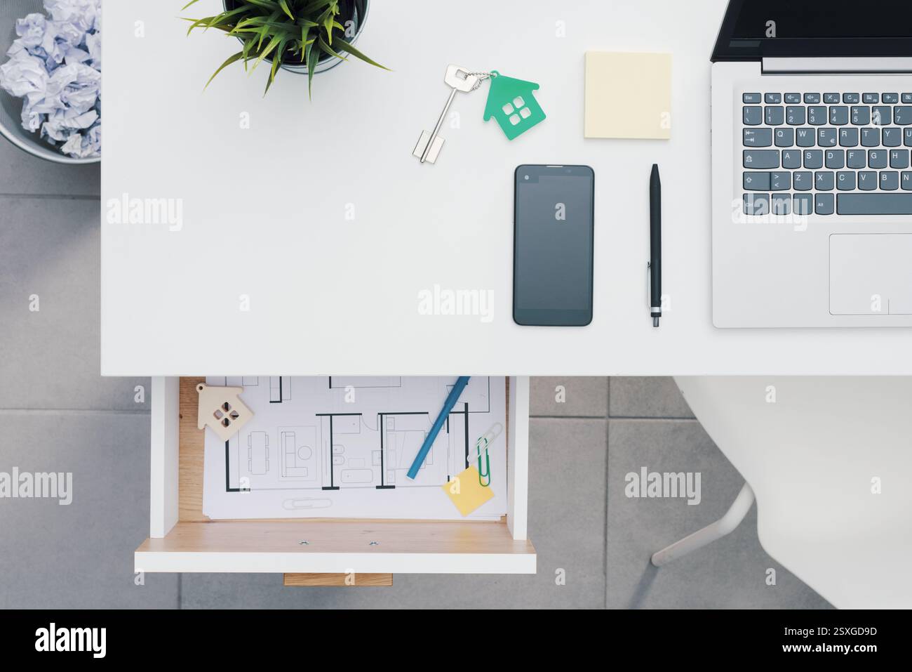 Real estate agent desktop with house plan in the drawer, home ...