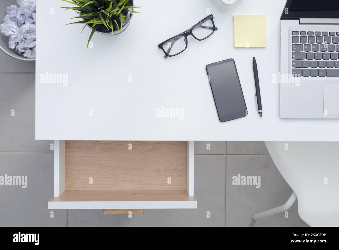 Tidy clean minimalistic office desktop with laptop, personal items and ...