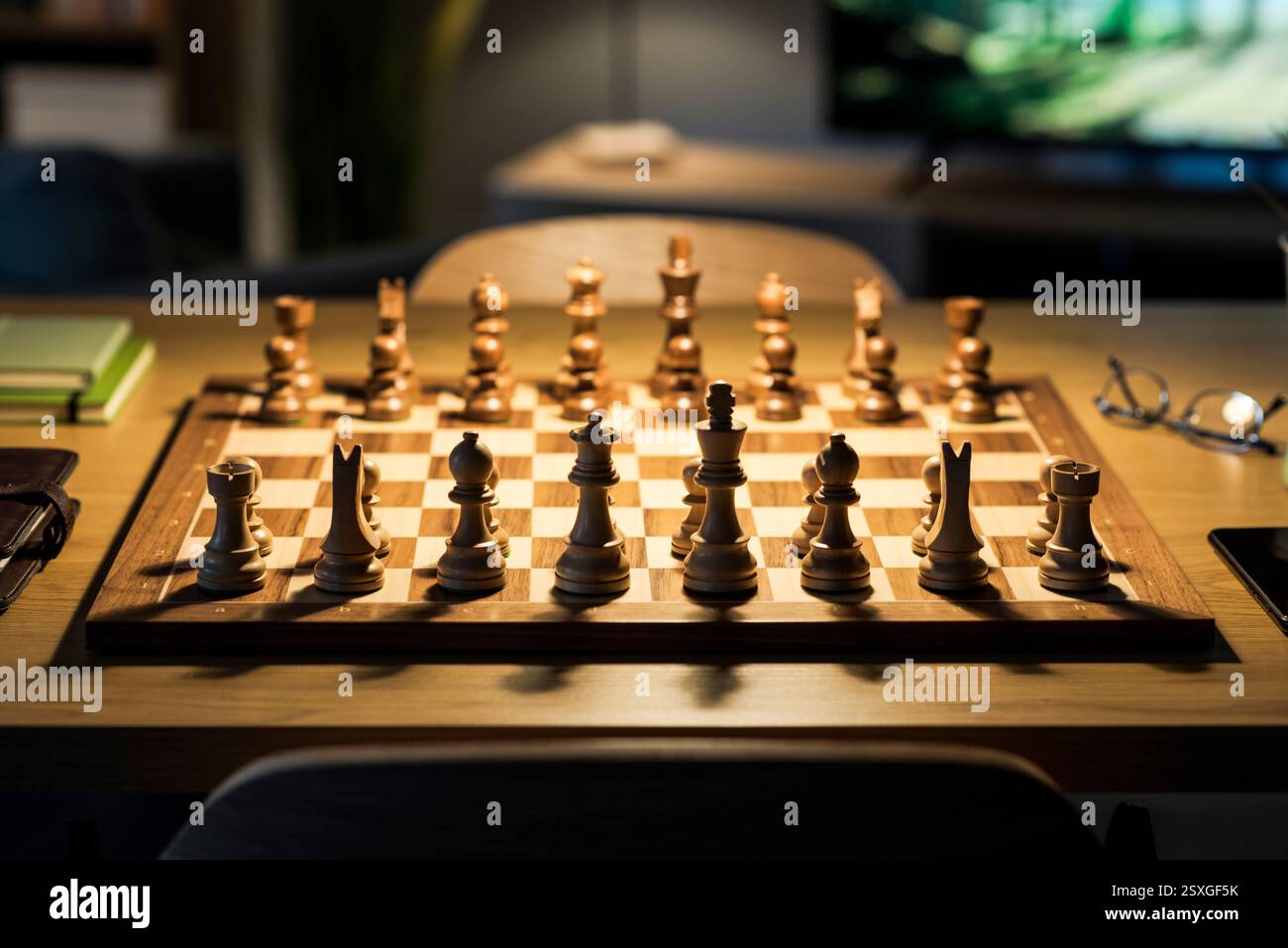 Wooden chessboard and chess pieces on a desk at home, competition and ...